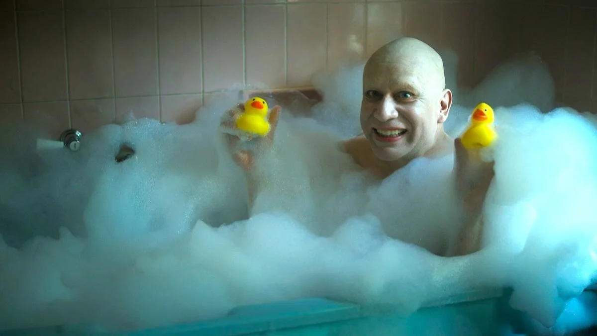 How Fred Armisen's Uncle Fester Returns in WEDNESDAY Season 2 - Nerdist